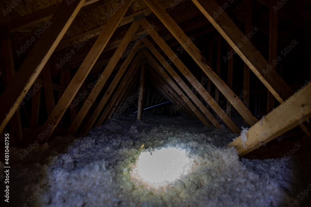 Dark attic with loose blown insulation seen throughout. Stock Photo ...