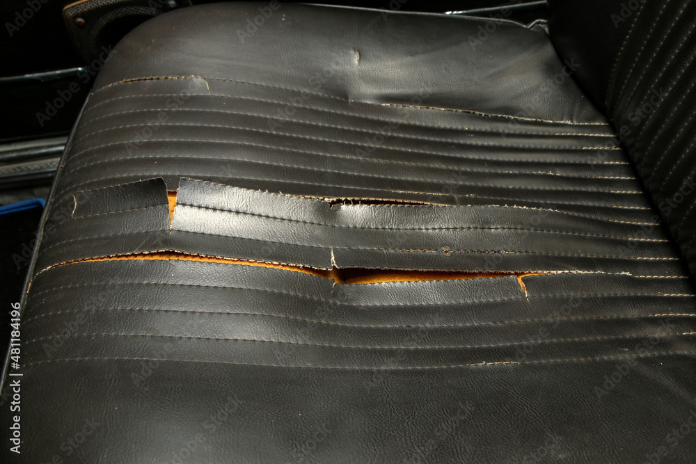 The black artificial leather interior of the old classic car which ...