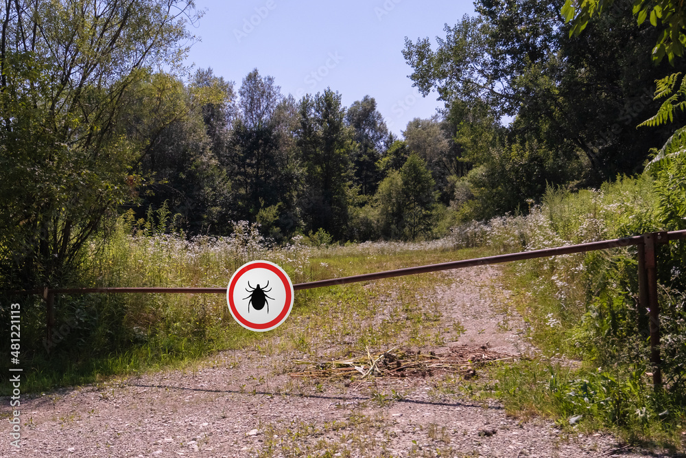 Warning sign beware of ticks in infested area in the forest. Stock ...