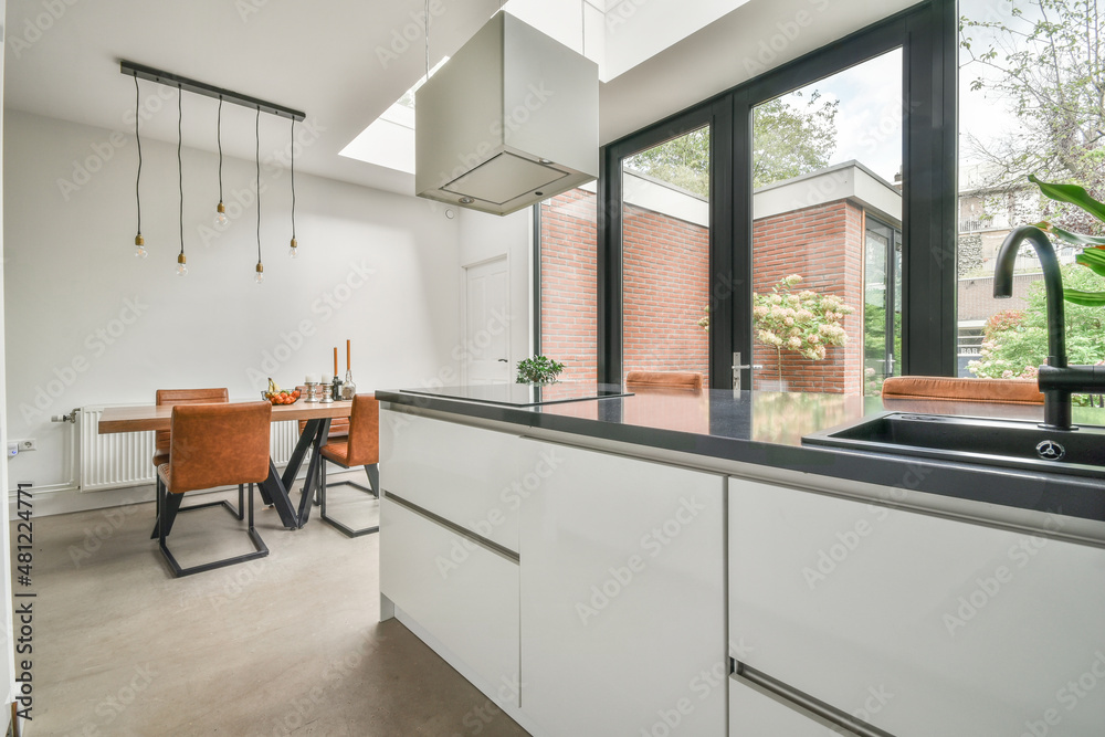 Interior of modern kitchen with counter opposite window Stock Photo ...