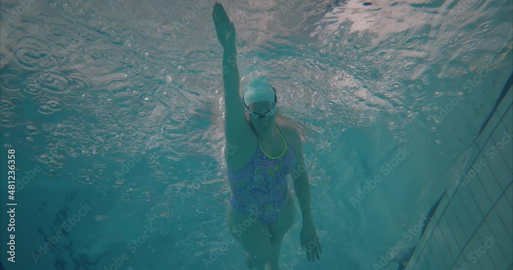 Underwater view, professional female swimmer swims in crawl and ...