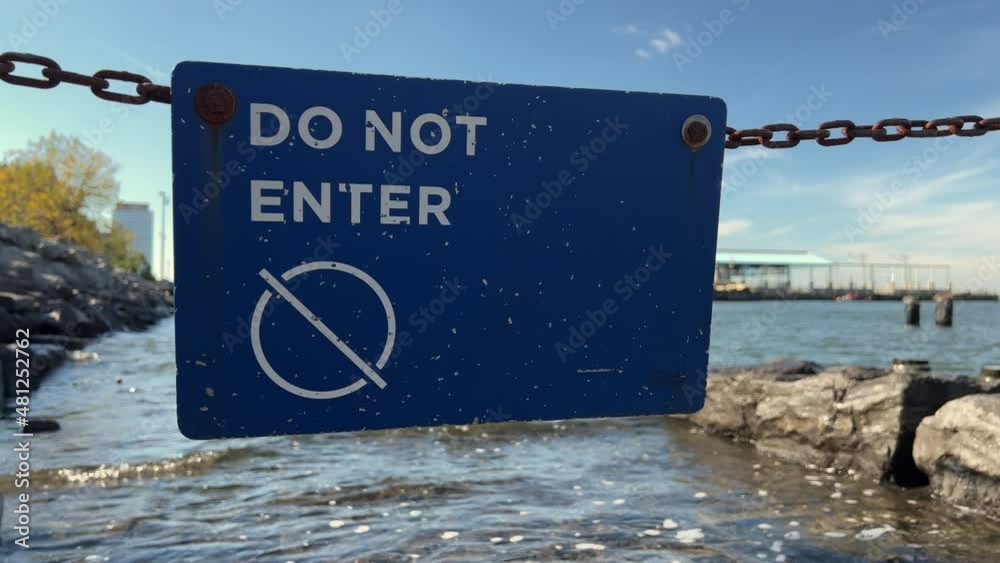 Do not enter sign. Blue prohibition sign, fence. Descent into water for ...