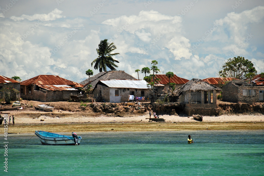 African beach scenery with traditional houses in the back and the ...
