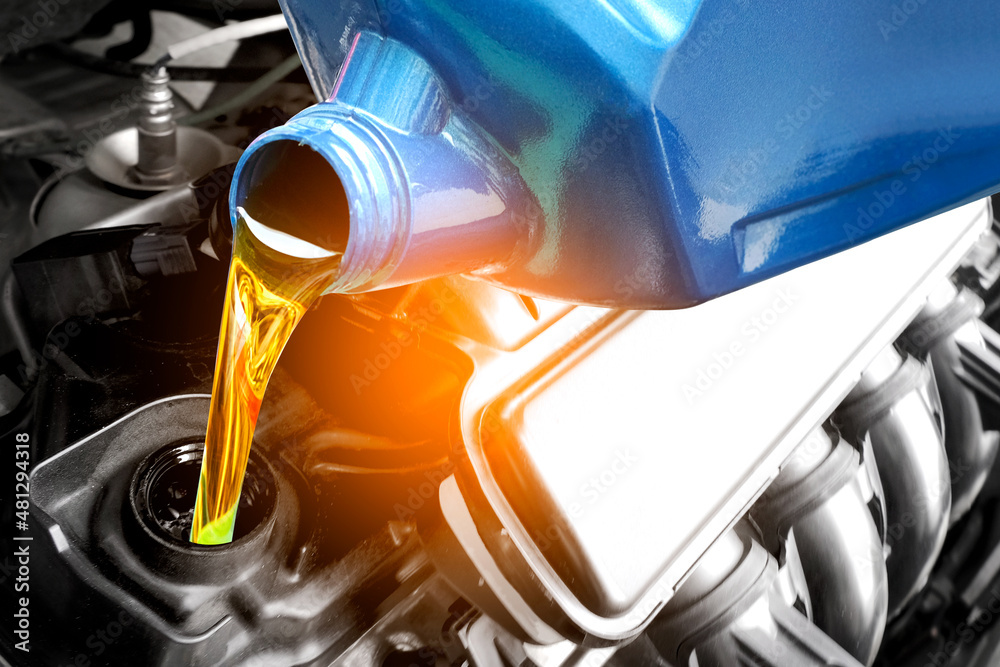 Refueling and pouring oil quality into the engine motor car ...