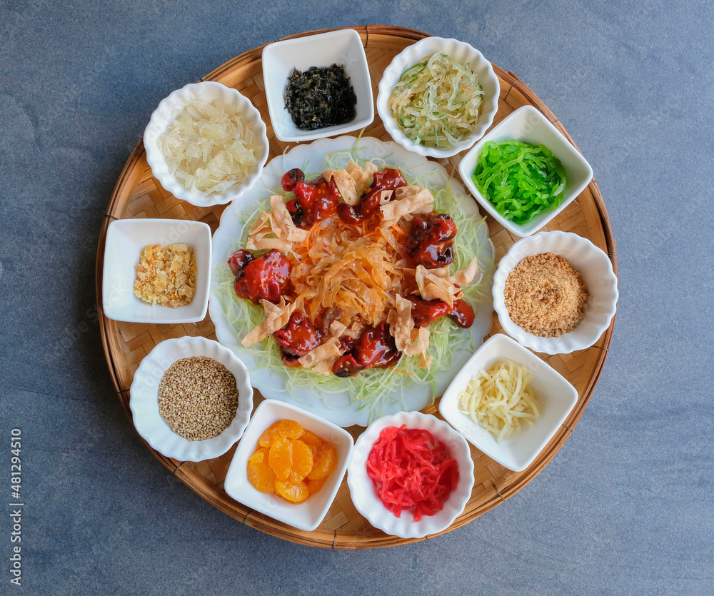 Modern Chinese fish salad. Lo Hei aka Prosperity Toss. Small bowls of ...