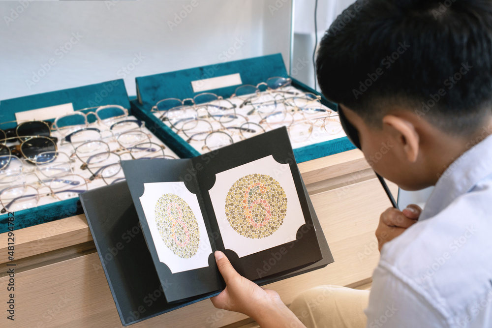 Indian child boy get color blindness tested with color blindness cards ...
