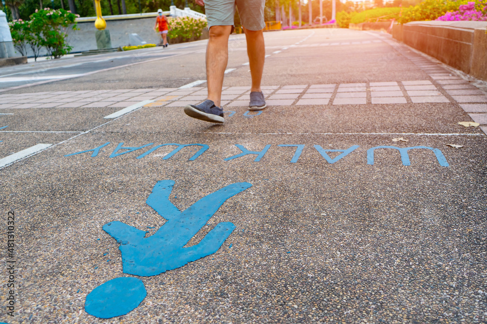 focus at painted a portrait of blue person on the pavement, Runner feet ...