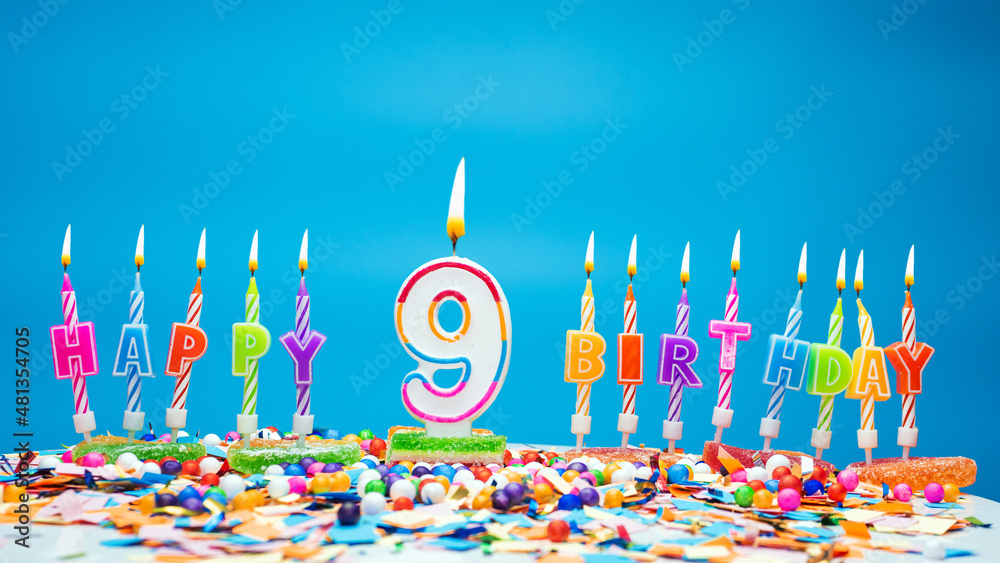 Happy birthday candle letters with number nine on a beautiful blue ...