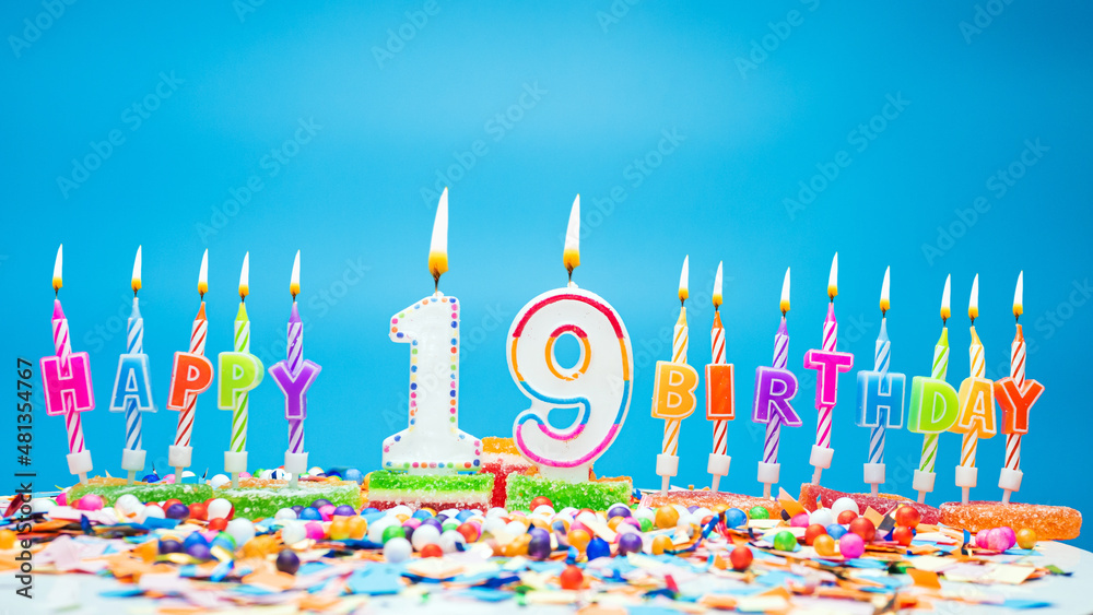 Happy birthday candle letters with the number nineteen on a beautiful ...