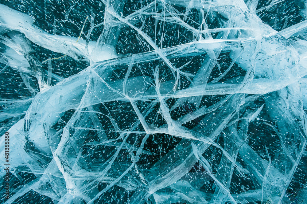 Texture of beautiful blue ice with cracks and air bubbles in the frozen ...