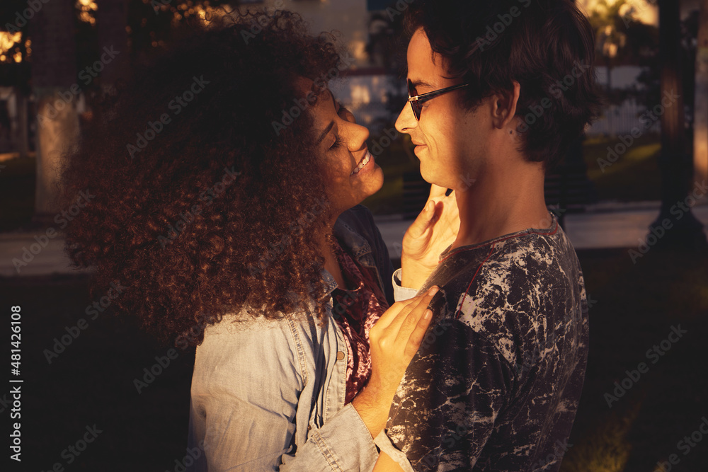 young loving interracial couple kissing outdoors Stock Photo | Adobe Stock
