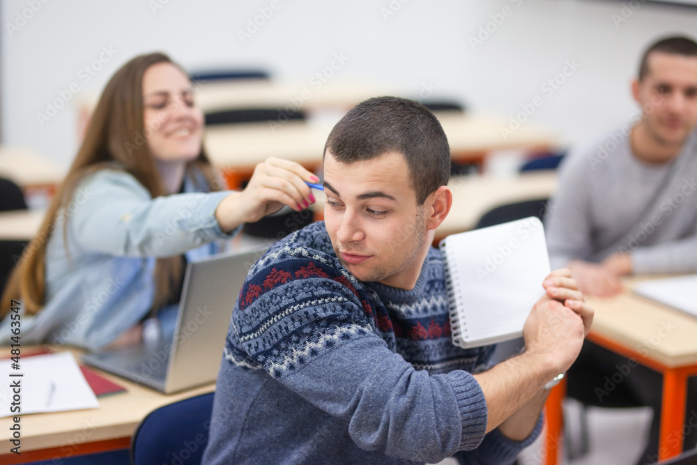 Students teasing each other having fun during class in a modern ...