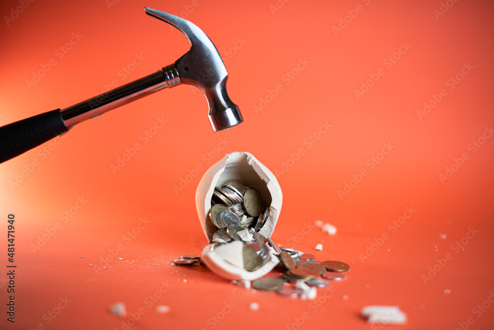 Breaking a clay money box with a steel hammer. Clay money box. Stock ...