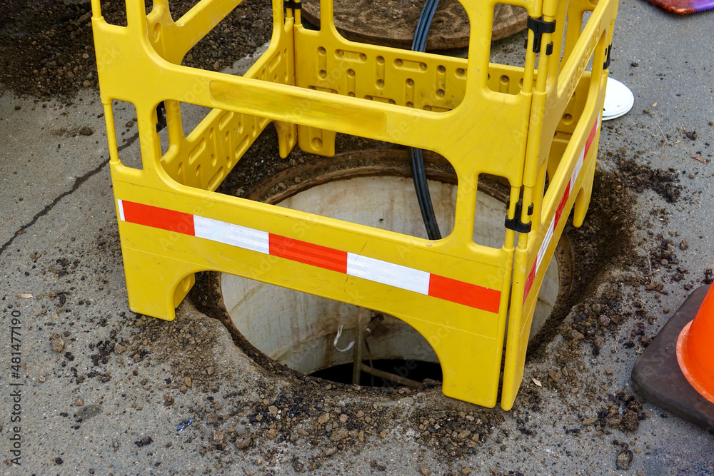 safety barrier around open manhole in the street Stock Photo | Adobe Stock