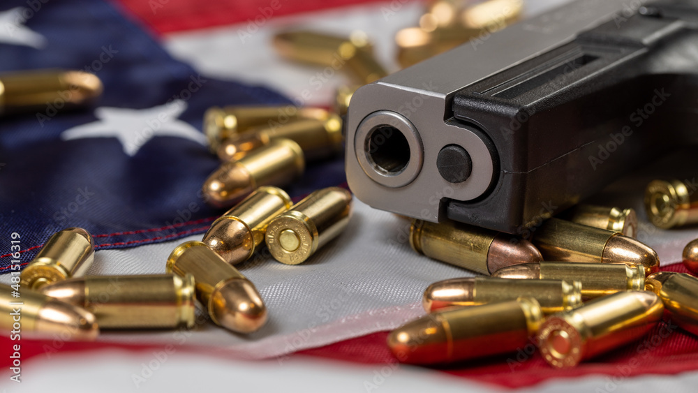 Detail of gun barrel with many bullets on American flag. Concept of gun ...