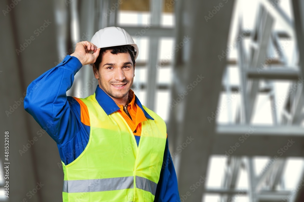 Male construction site manager standing wearing safety vest and helmet ...