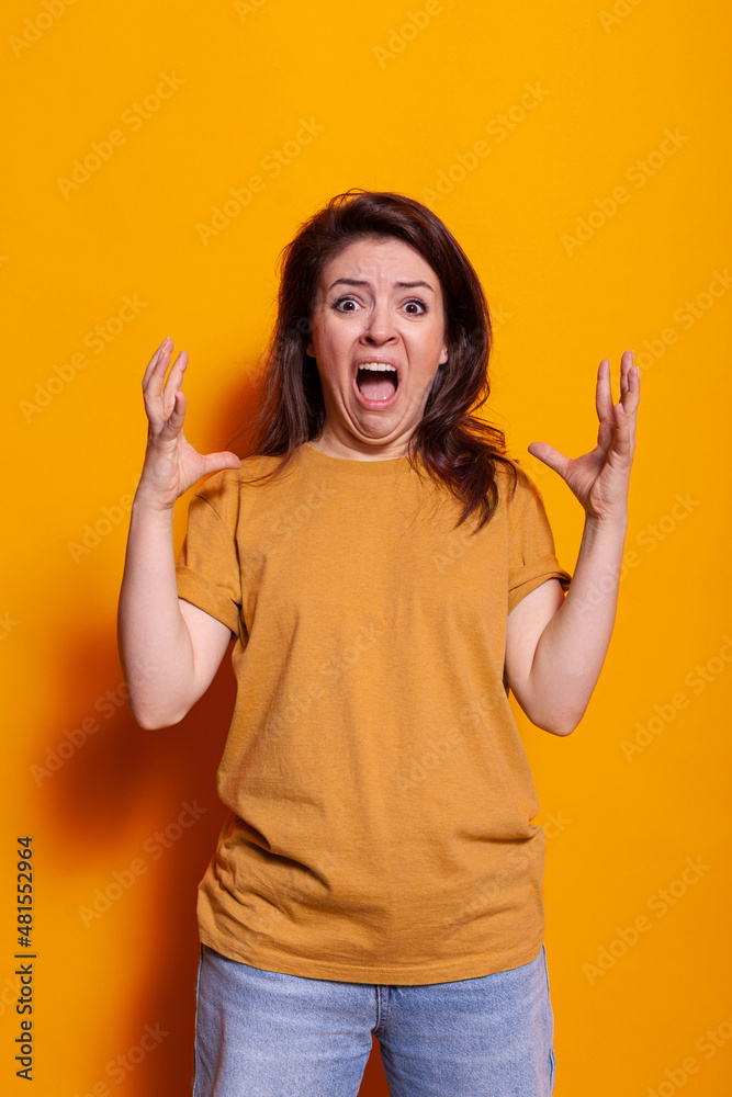 Frightened woman showing face expression of despair, standing over ...