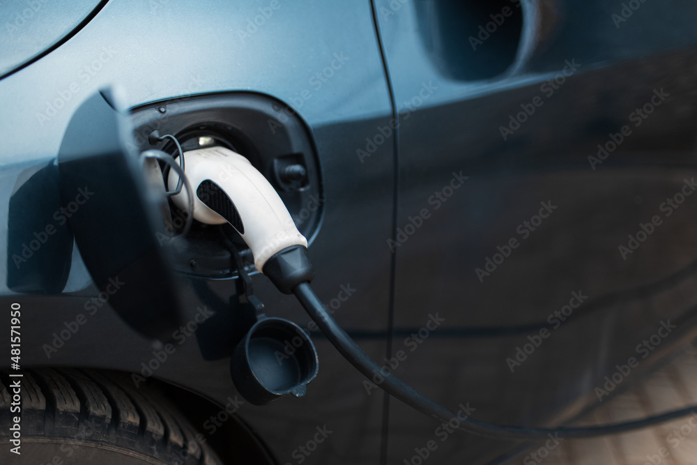 Power cable of plug-in hybrid car on charging station. Stock Photo ...