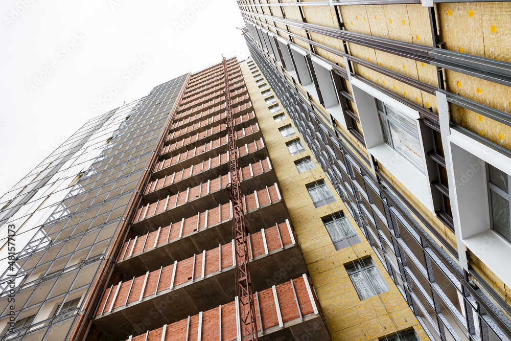 The corner of a high-rise building, the construction of the facade and ...