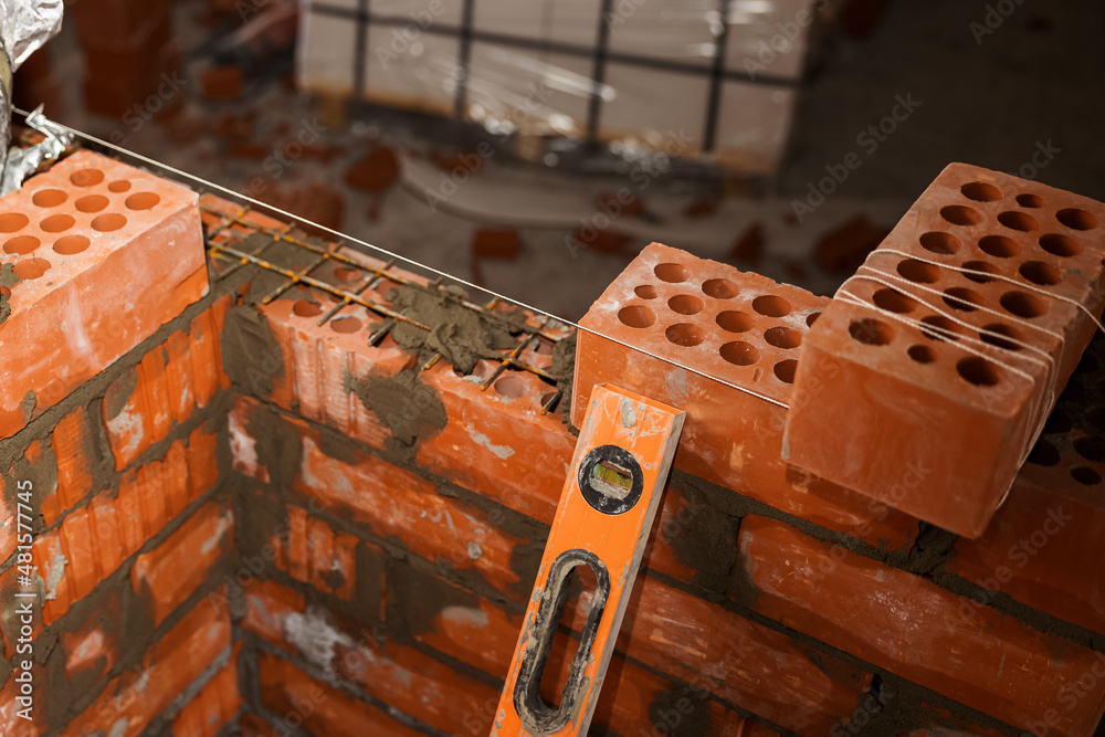 Brickwork of red lightweight clay bricks. Construction of the wall with ...