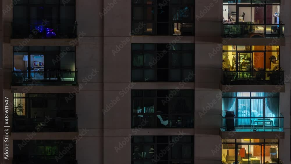 Windows of apartment building at night timelapse, the light from ...