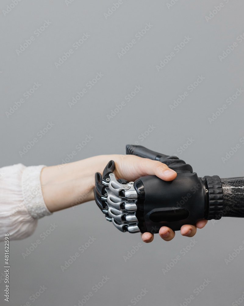 the human hand and the siber hand bionic prosthesis make a handshake ...