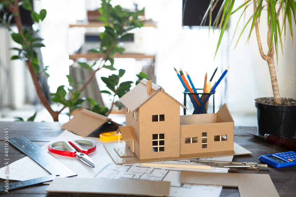 Workplace of architect - construction drawings, scale model and tools ...