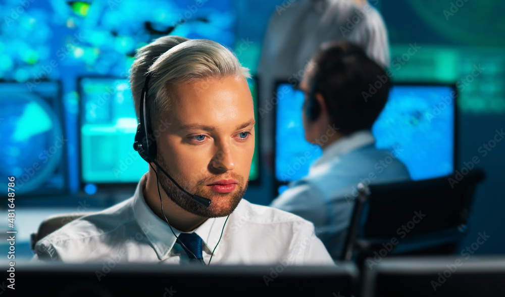 Aircraft flight control officer monitors the approach of aircraft from ...