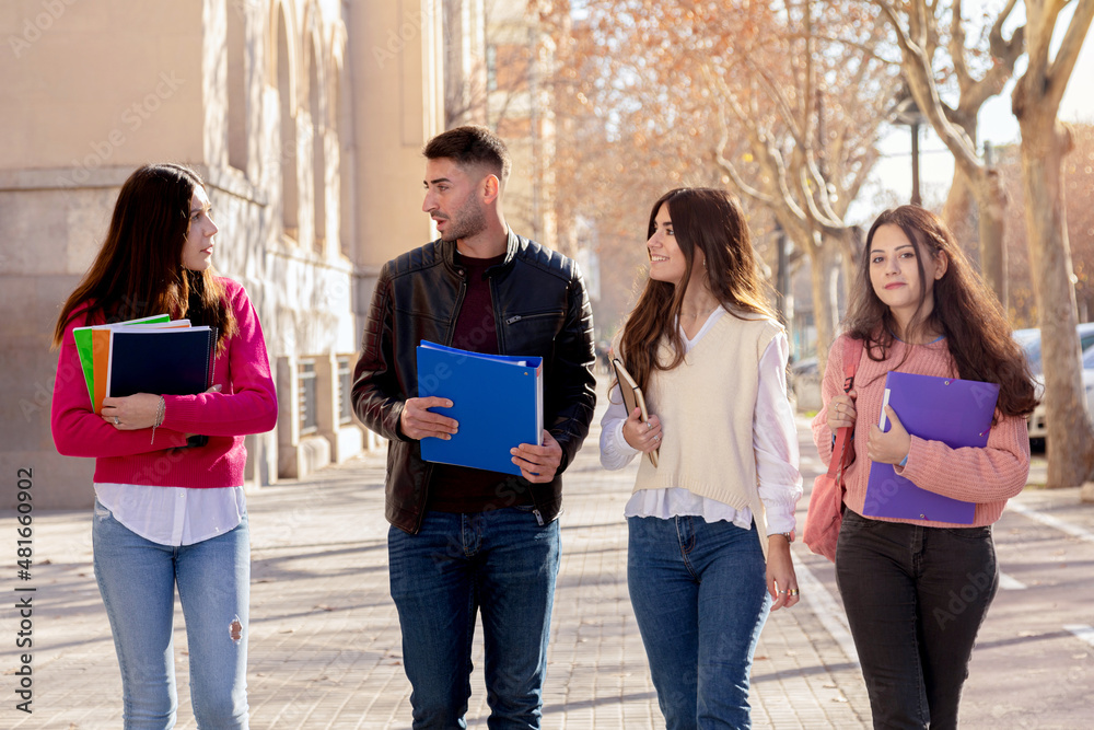 Four college students talking and interacting on campus. three girls ...