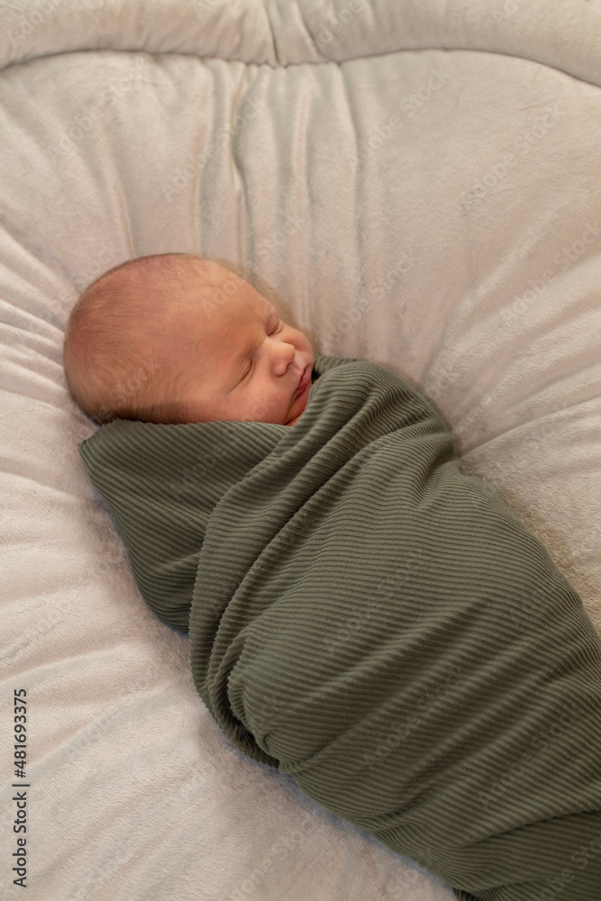 Newborn baby swaddled and sleeping. Stock Photo | Adobe Stock