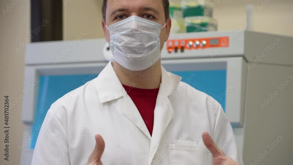 Confident doctor in mask talking look camera biomedical laboratory ...