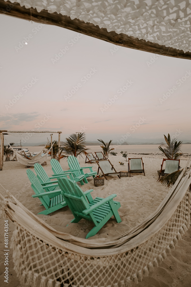 A relaxing scene of a secluded and peaceful beach setup, hammock ...