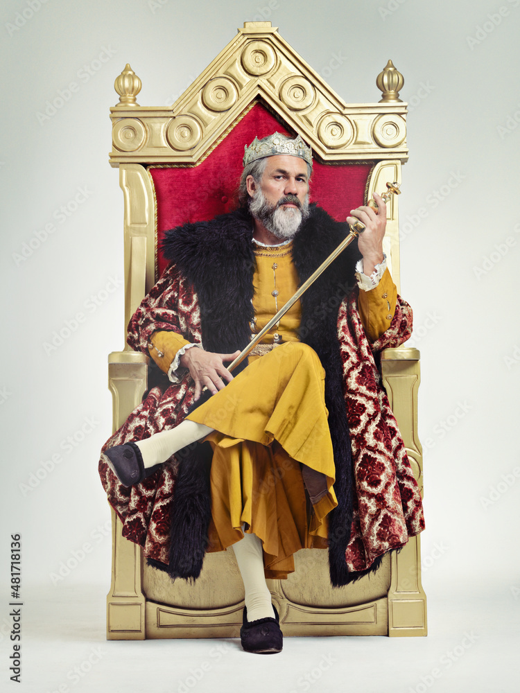 Throne of the kings. Studio shot of a richly garbed king sitting on a ...