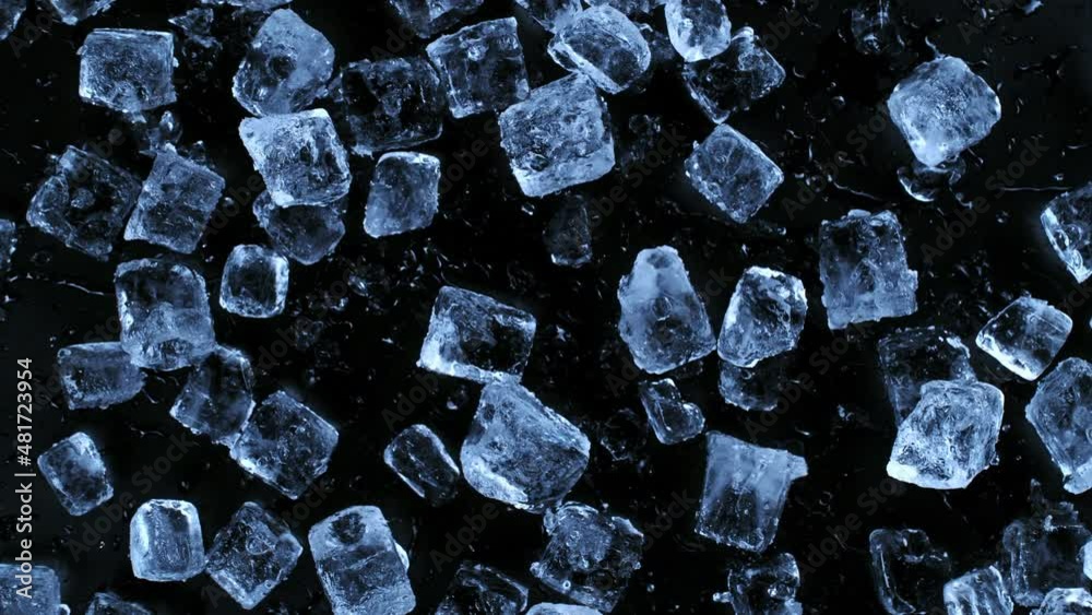 Super slow motion of falling ice cubes separated on black background ...