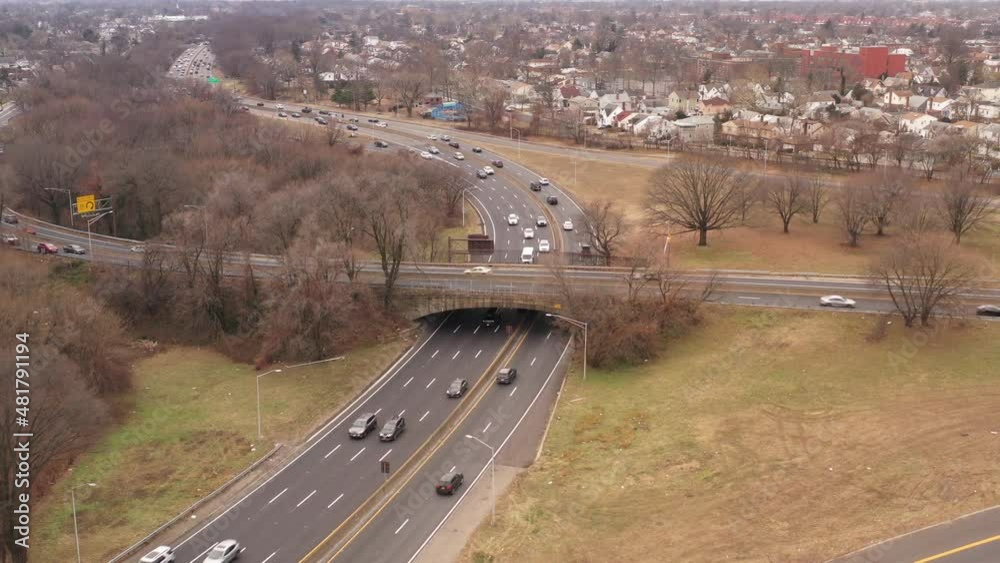 An aerial view of a highway intersection, one road crossing over the ...