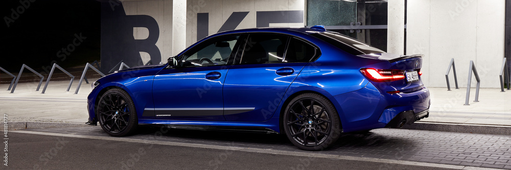 BMW 330i with M Performance package. Parked at night next to bicycle ...