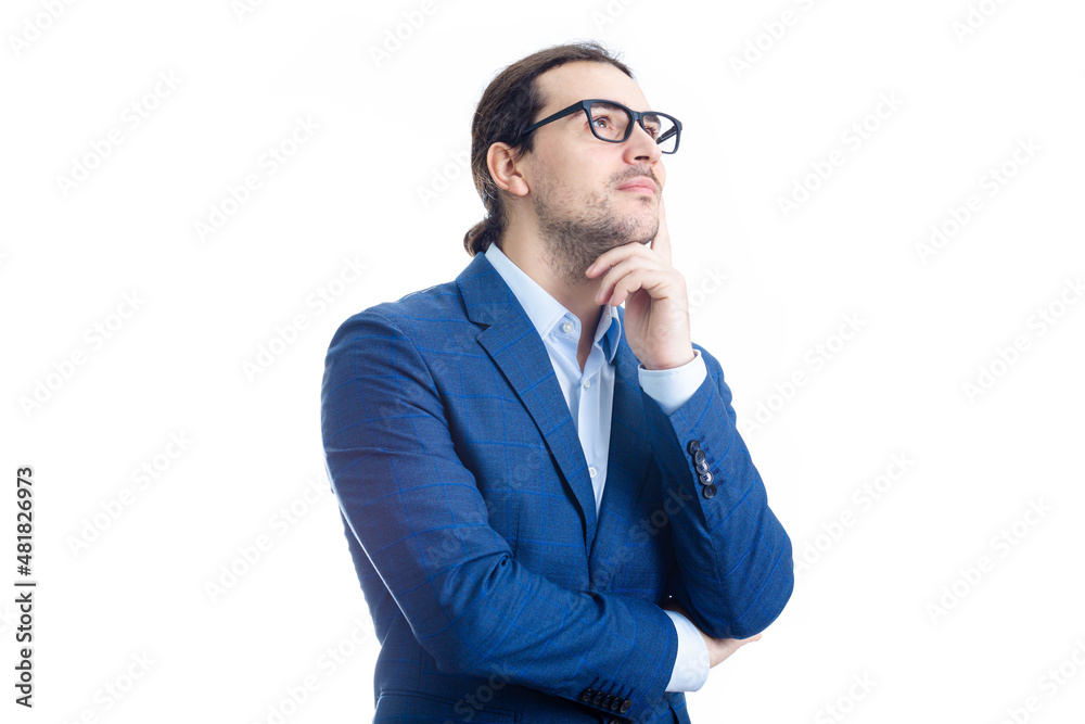 Thoughtful businessman keeps hand under chin, looking up pensive ...