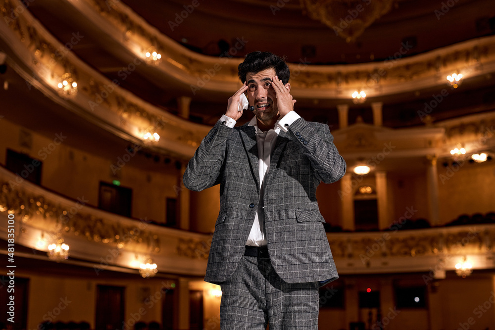 An alarmed actor or singer who is afraid of public speaking, holding a ...