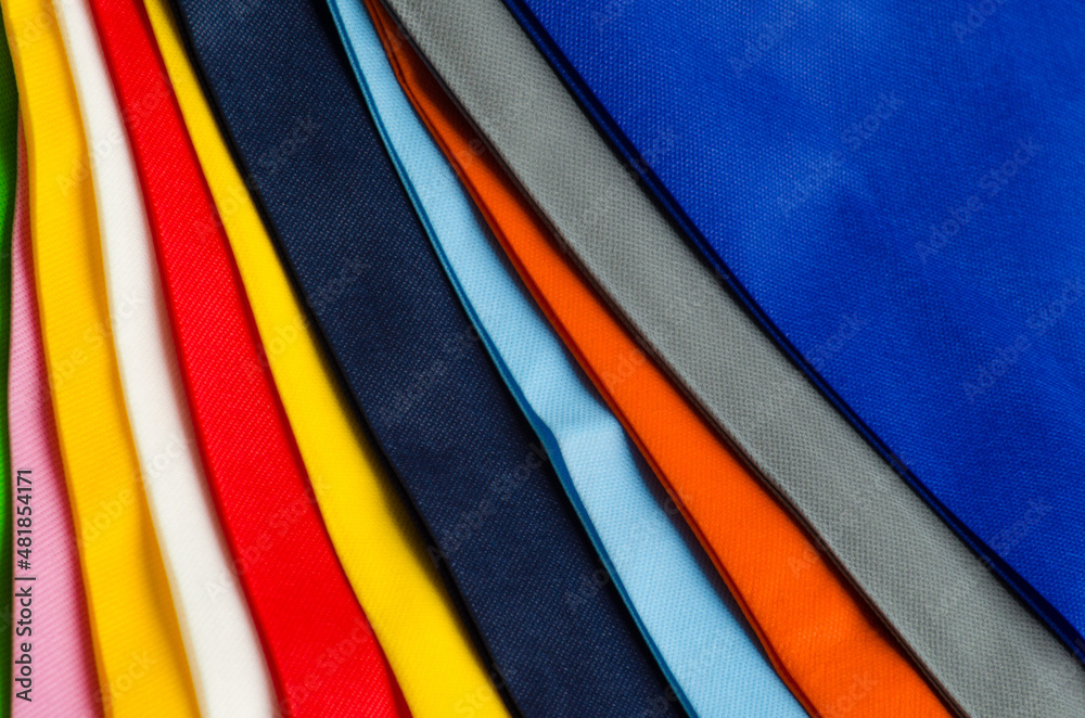 colorful non-woven fabric tote bag texture. pile of textured and porous ...