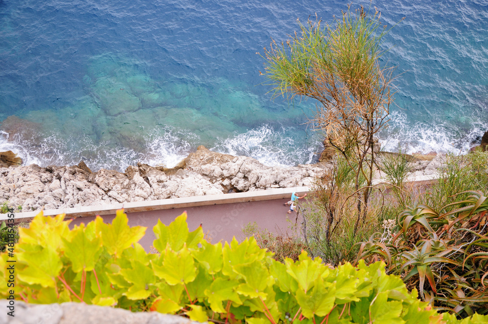 Beautiful concrete embankment in the Fisherman Cove in Monaco. Rocky ...