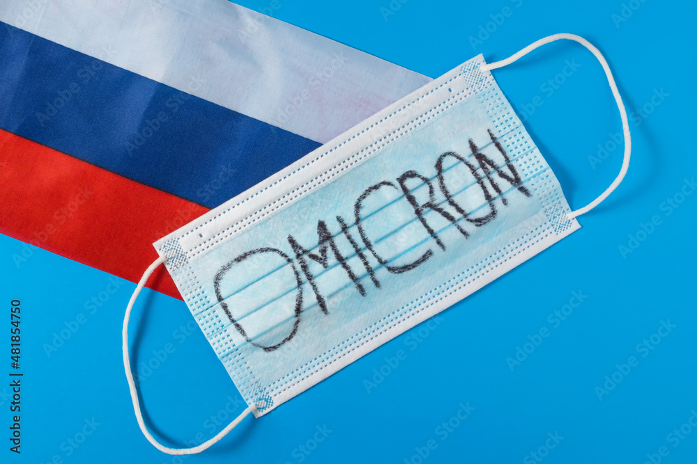 The flag of the Russian Federation and a medical mask with the word ...