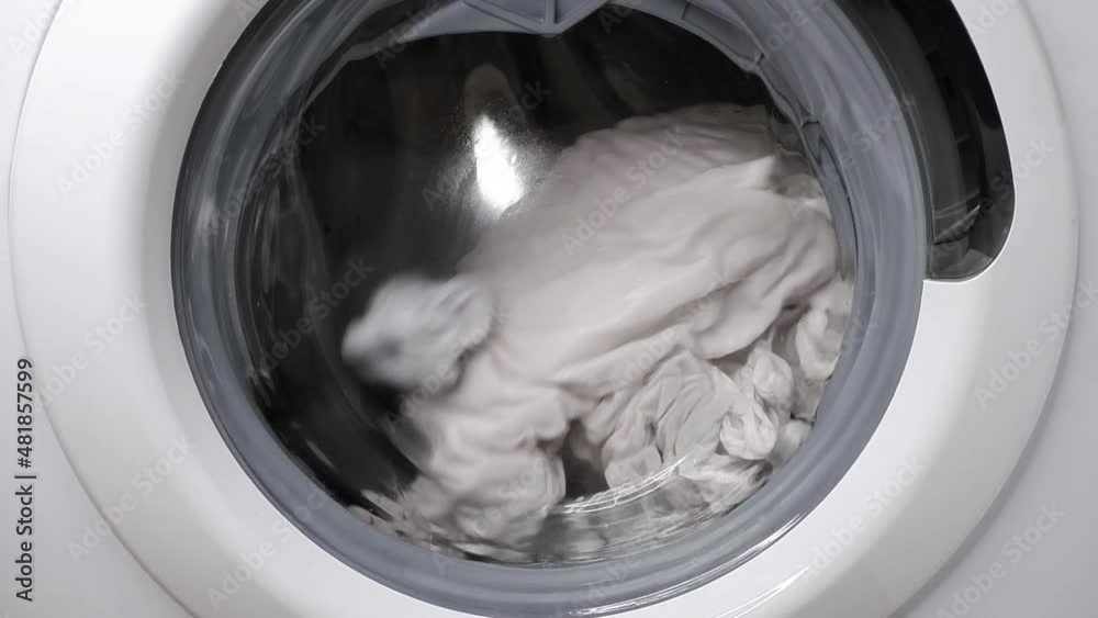 Washing clothes in a washing machine. Slow motion. Stock ビデオ | Adobe Stock