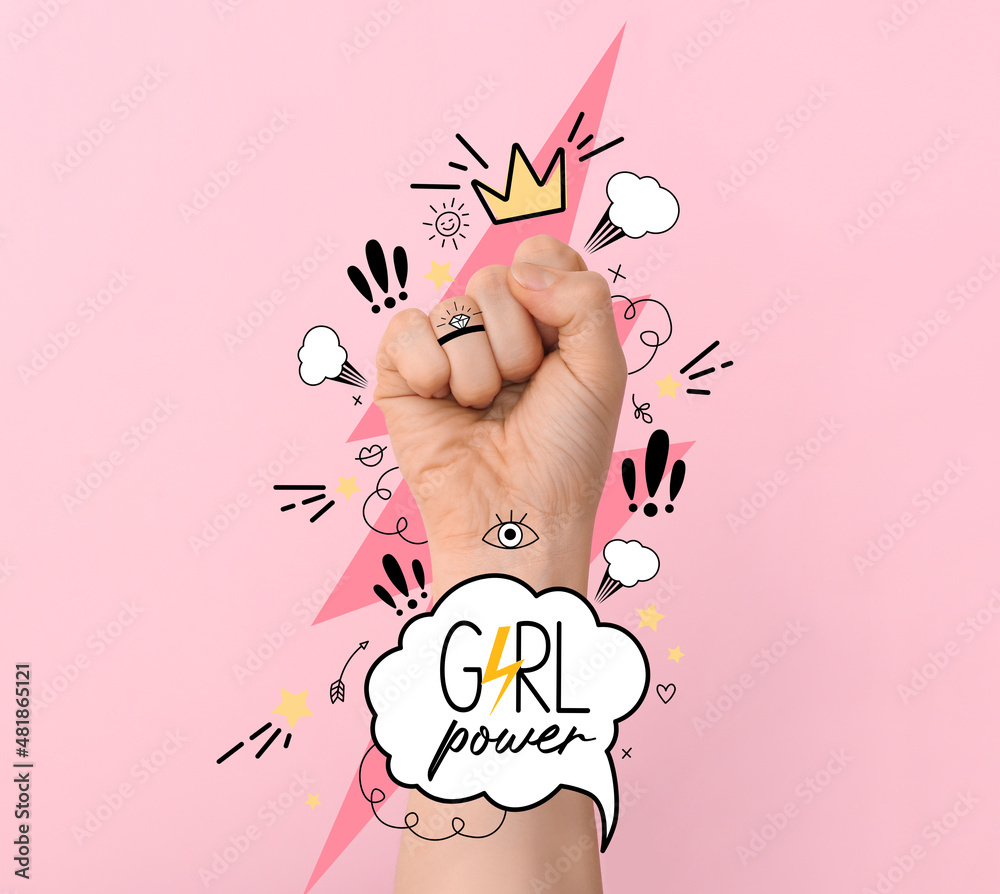Hand of woman with clenched fist and text GIRL POWER on pink background ...