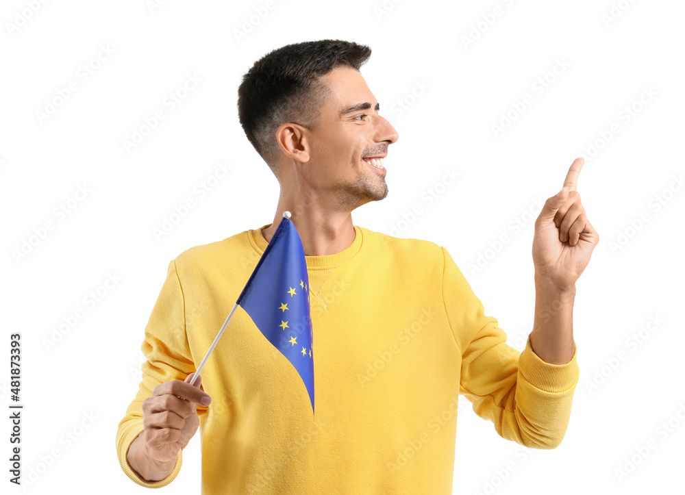 Young man with flag of European Union pointing at something on white ...