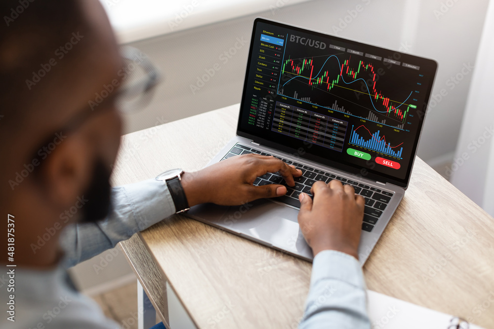 Black Businessman Using Laptop, Trading Online, High-angle View - Stock ...
