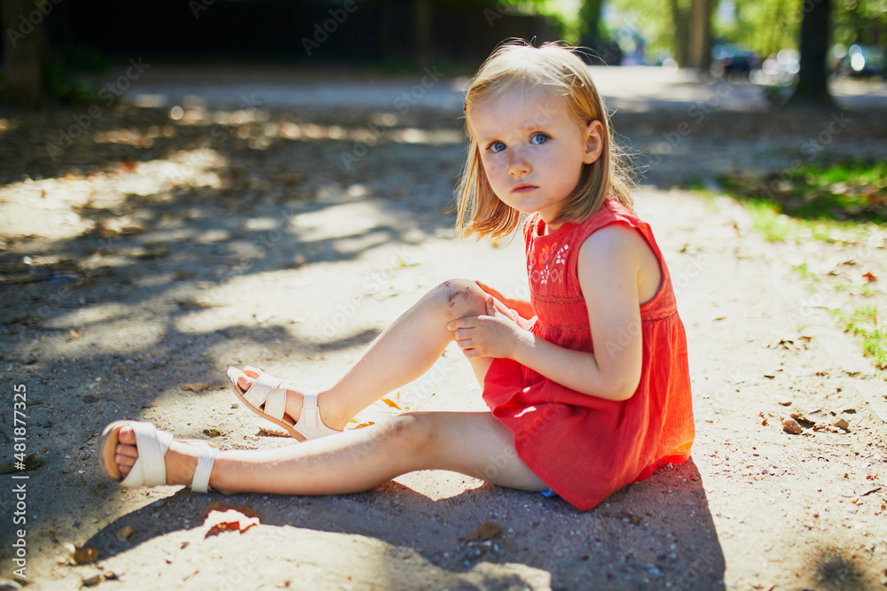 Cute little girl sitting on the ground after falling down Stock Photo ...