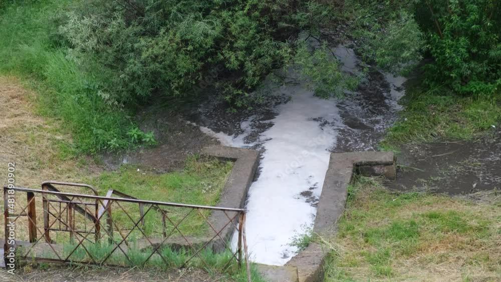 Hard rainwater pouring out and a drain spout after a day of heavy rains ...