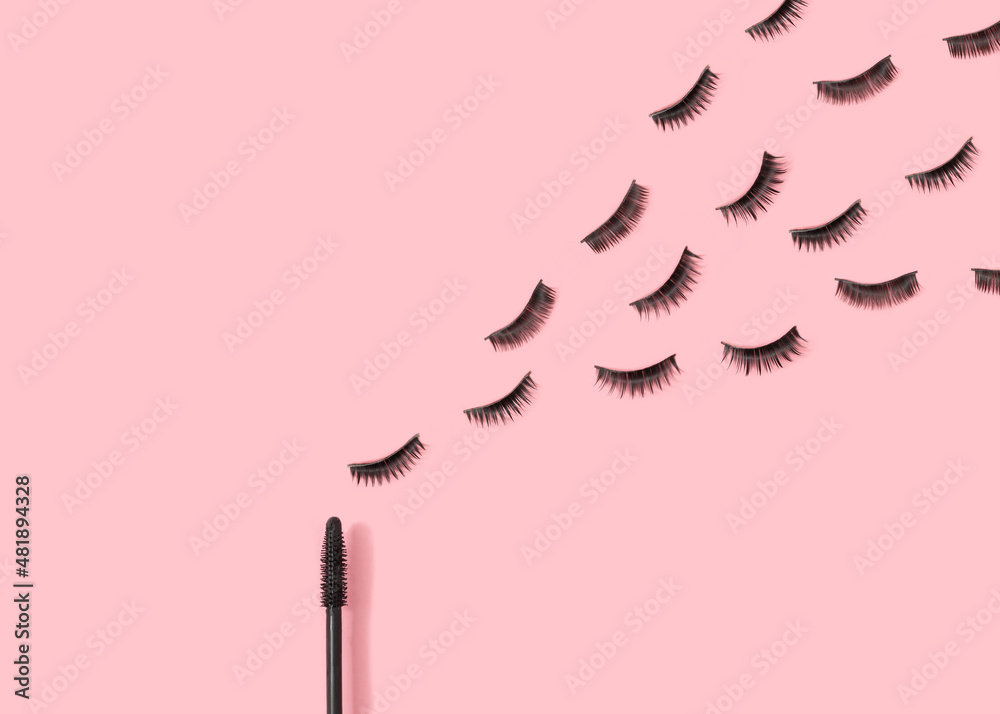 Eyelashes and mascara brush on pastel pink background. Creative makeup ...