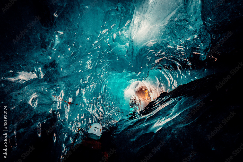 Explorer Going down Ice Cave in Iceland Stock Photo | Adobe Stock