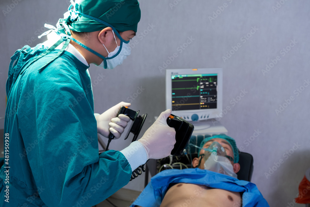 Selective focus at defibrillator while doctor use it to pump at chest ...